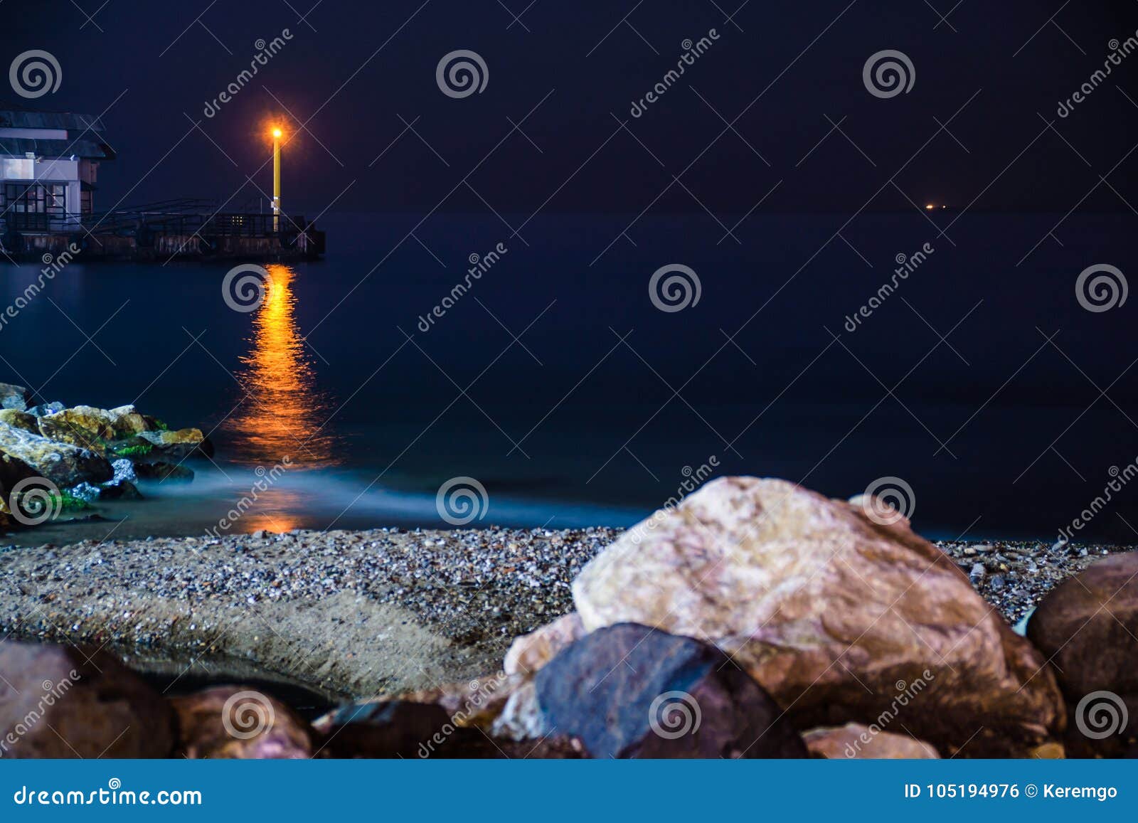 Magical Harbor at Night with Rocky Shore and Lights Stock Photo - Image ...