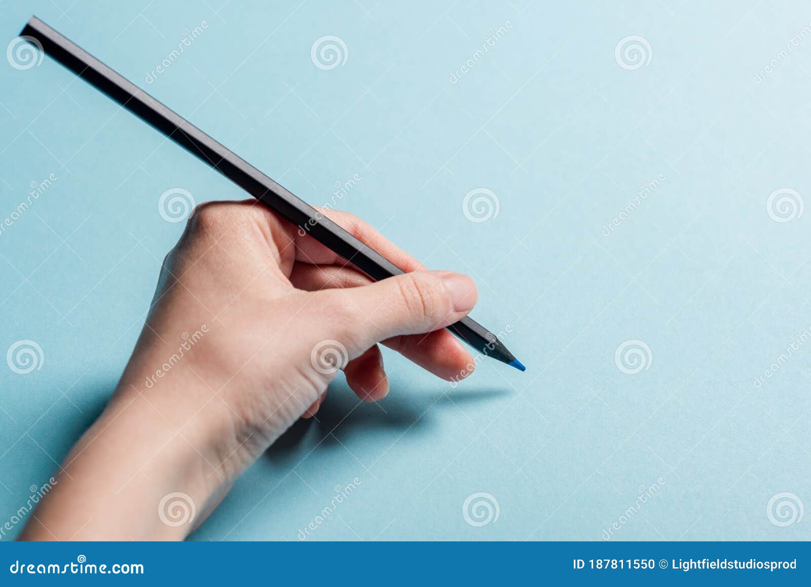 View of Man Holding Pencil on Stock Photo - Image of hand, blue: 187811550