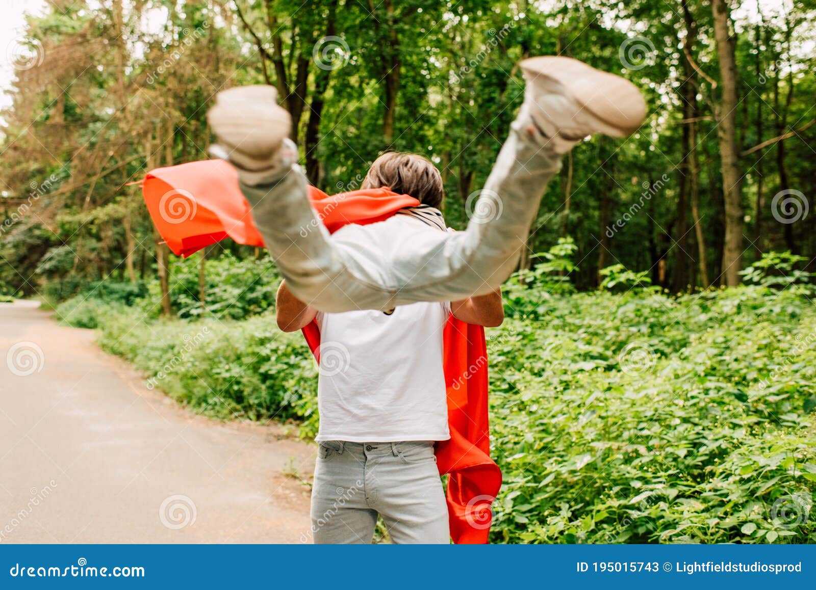 View of Man Spinning Around Boy in Red Cloak Stock Image - Image of ...