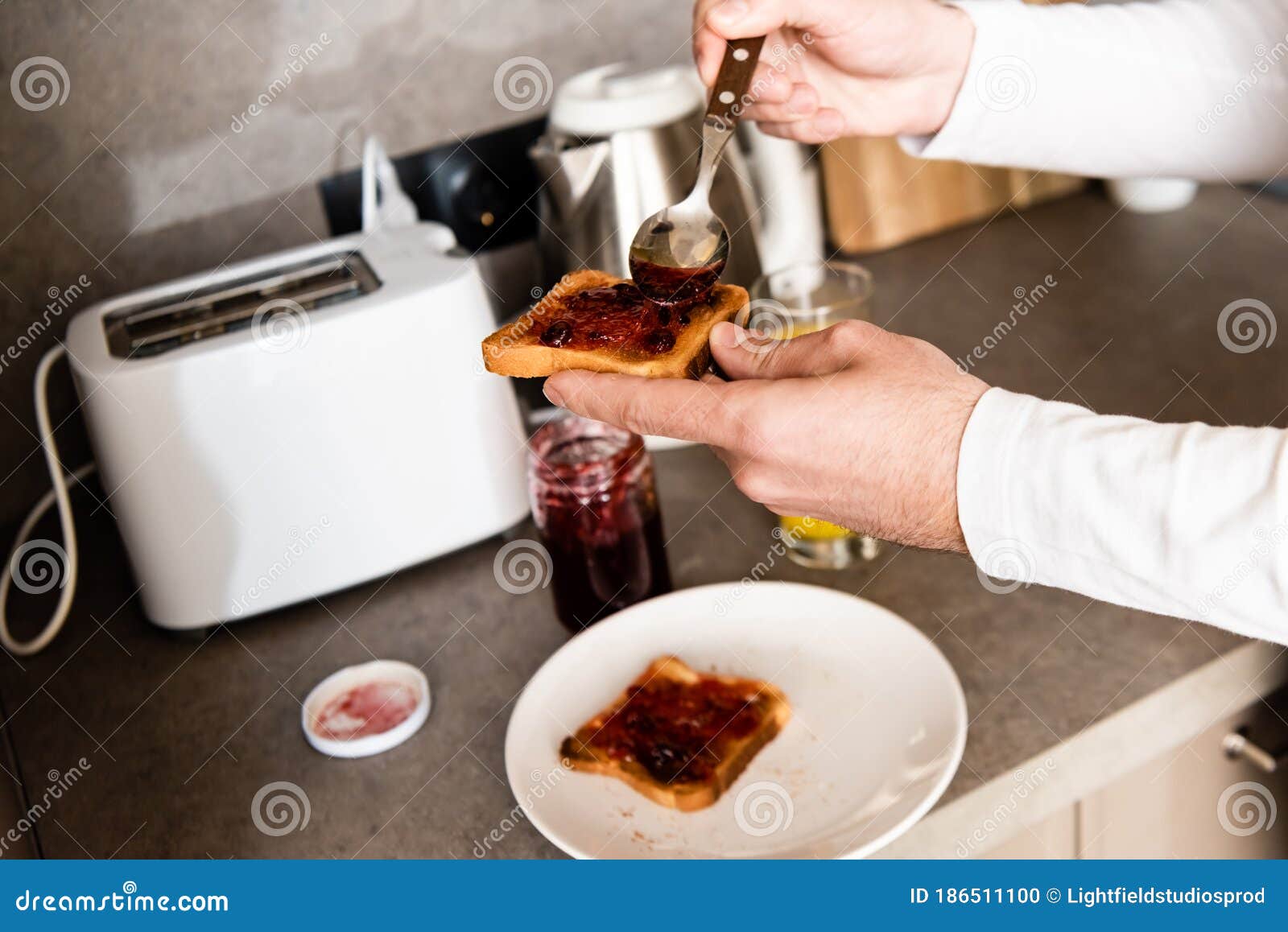 View of Man Spreading Jam on Stock Photo - Image of plate, tasty: 186511100