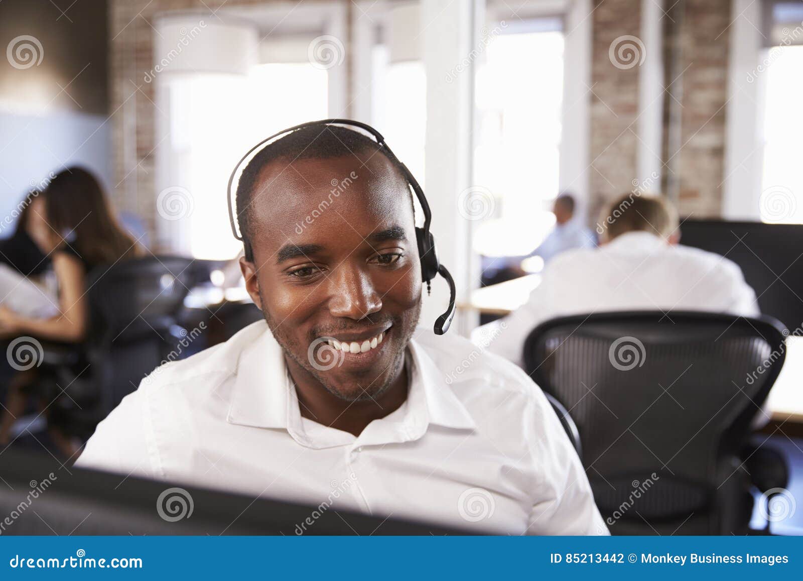 View of Man Working in Busy Customer Service Department Stock Photo ...