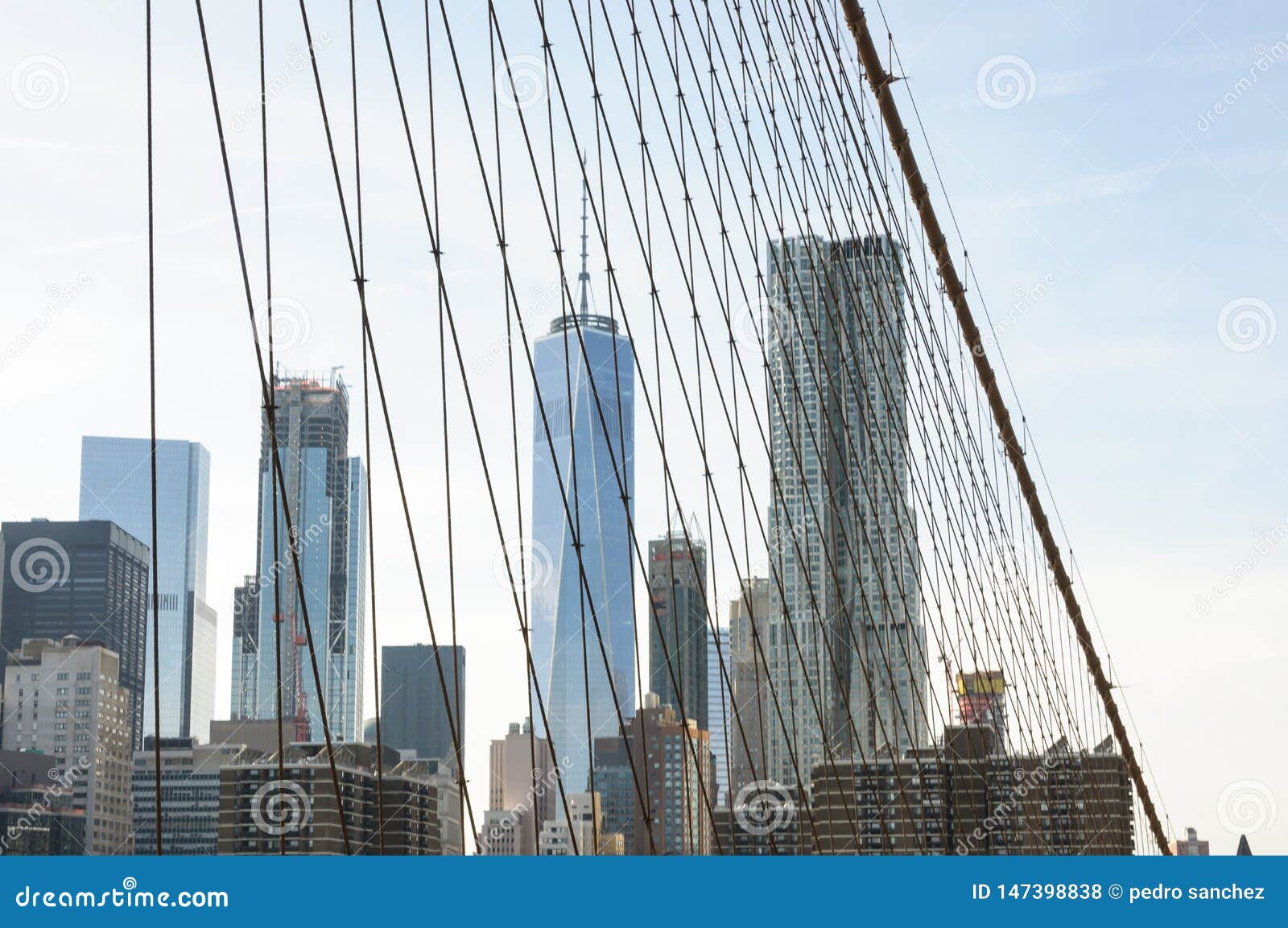 View of the Manhattan Skyline through the Wires of the Brooklyn Bridge ...