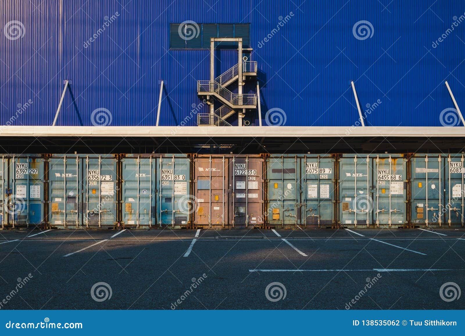 View of Many Shipping Containers Doors with Fire Escape Background ...