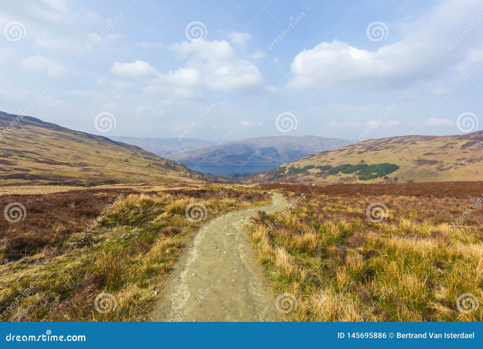 A View of a Mountain Valley with Path,grass and Lake in the Background ...