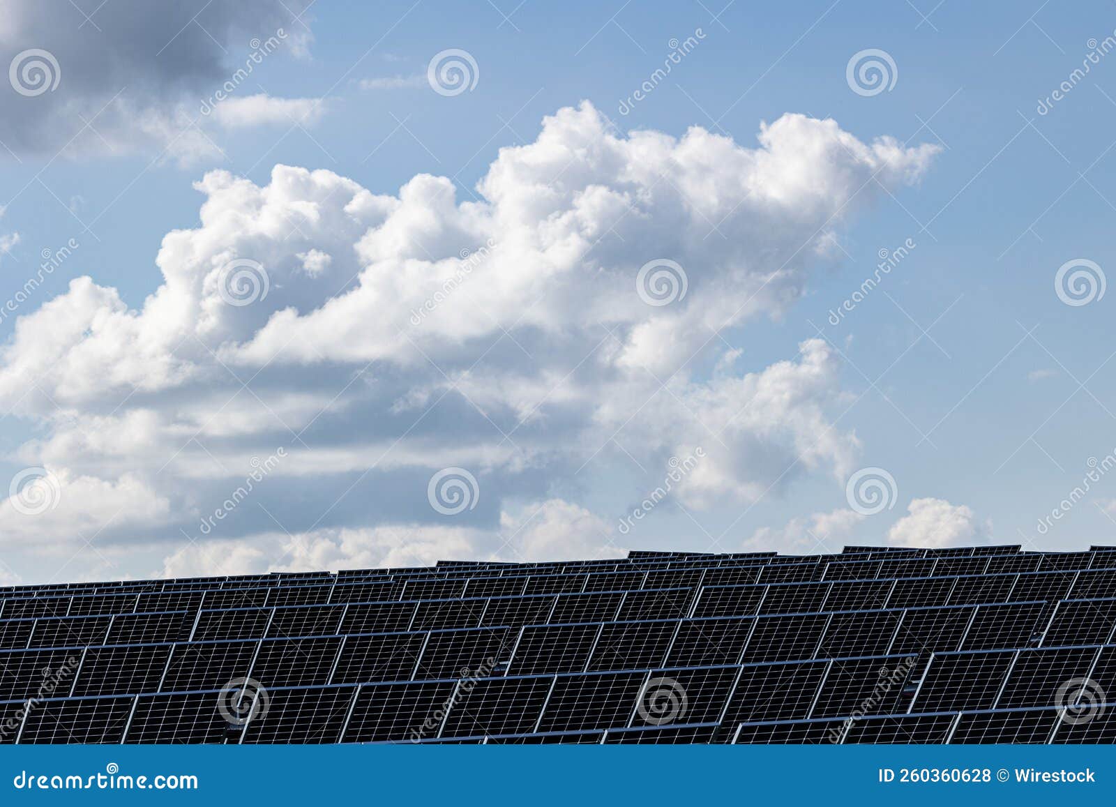 View of Multiple Solar Panels Against the Sunny Cloudy Sky Stock Photo ...