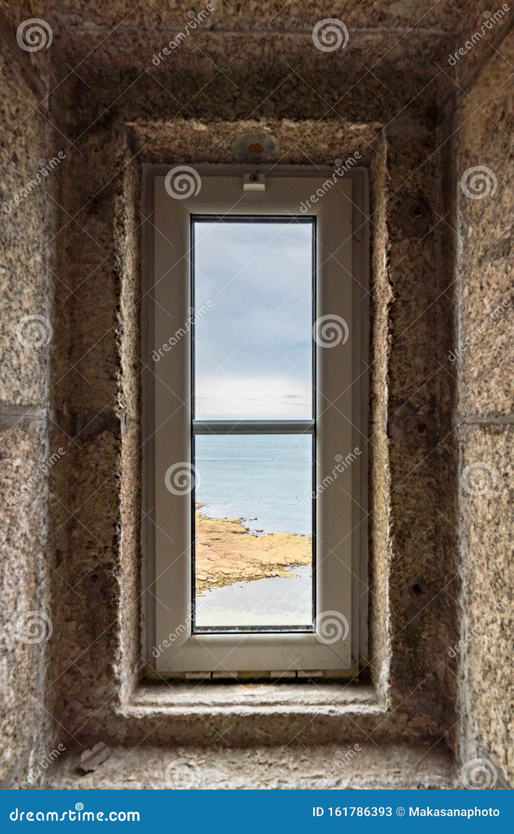 View of the Ocean through a Lighthouse Window in the Stone Staircase ...