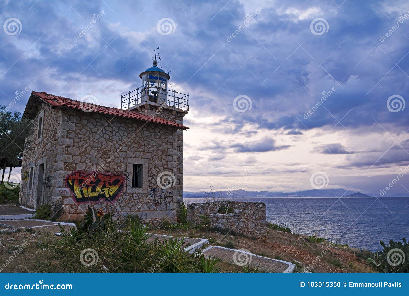 Abandoned Stone Lighthouse Under a Dramatic Sky, Greece. Stock Photo ...
