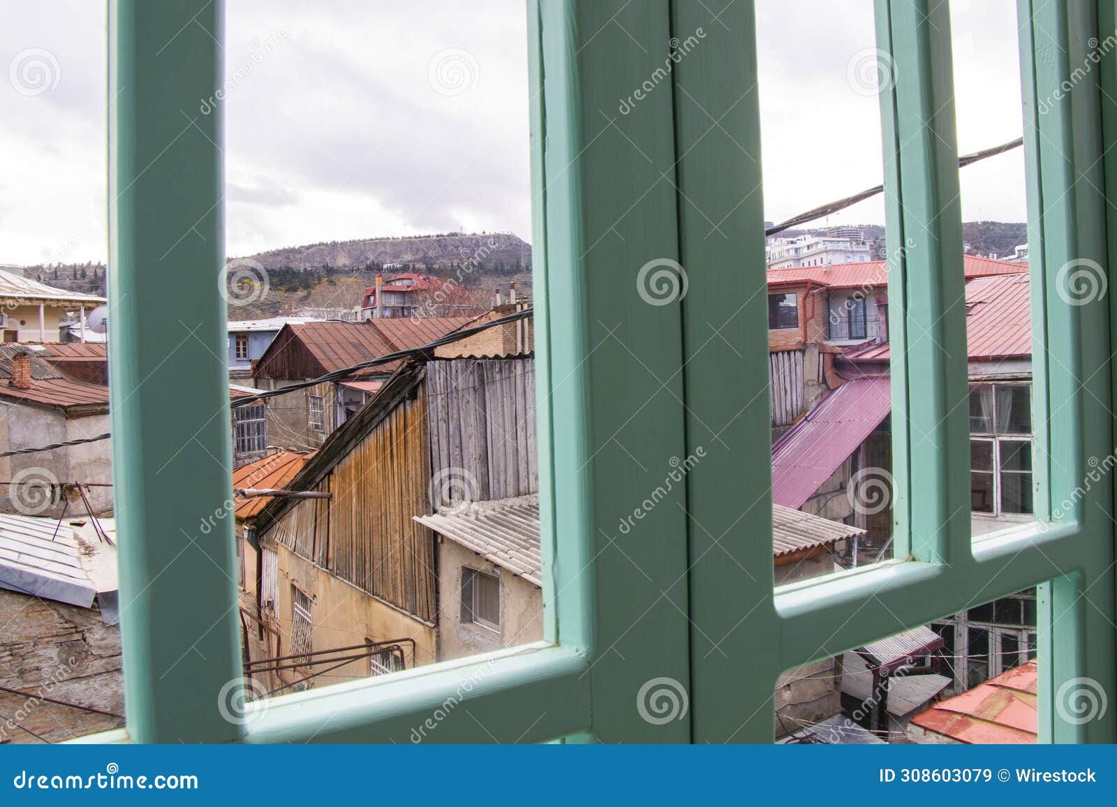 The View Outside of an Open Window Shows Several Buildings in the ...