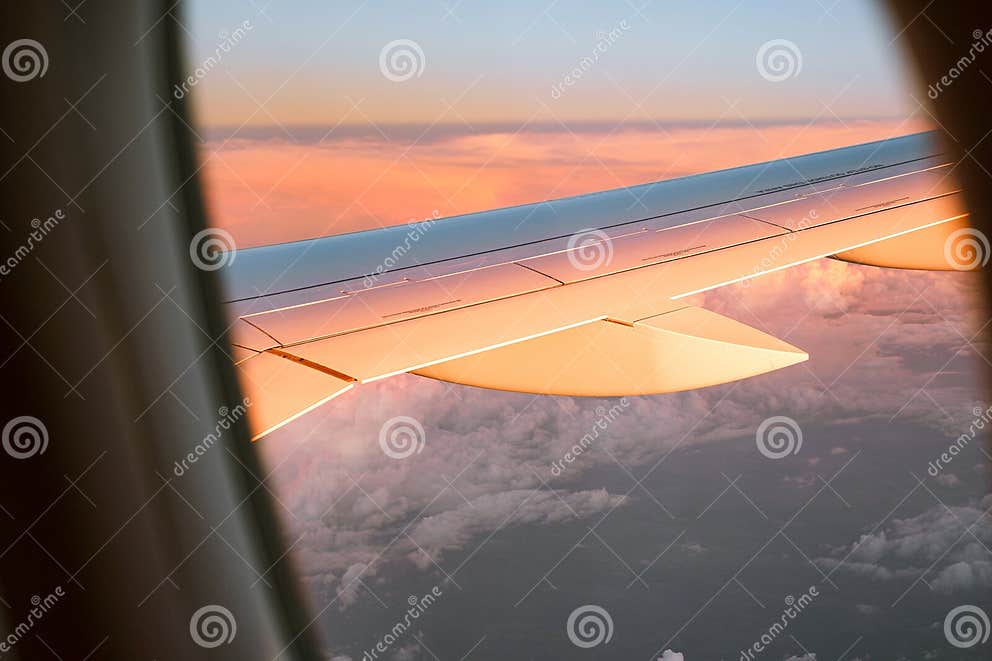 View Outside the Plane Window To the Wing and Clouds at Sunset Stock ...