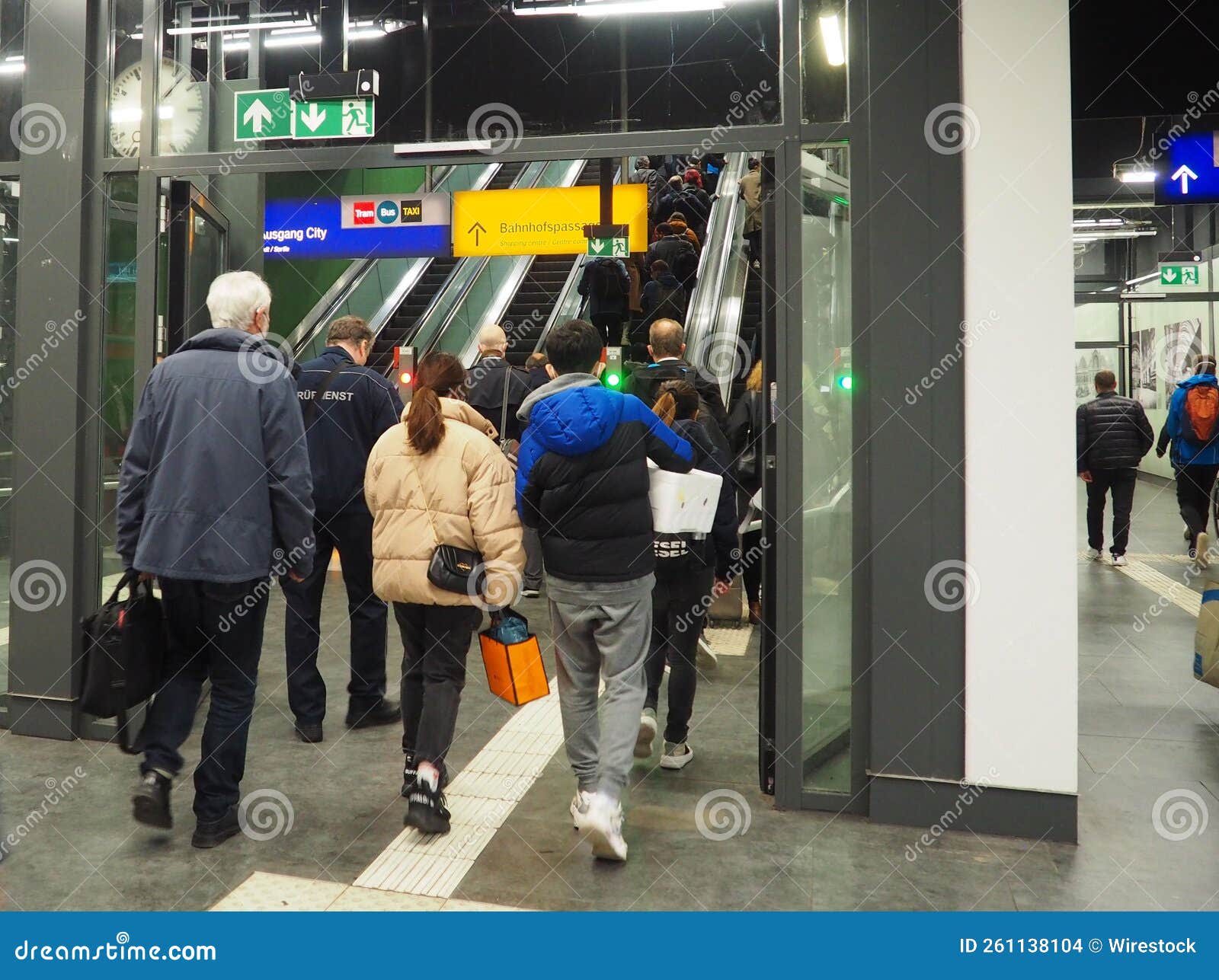 View of People Taking the Escalator - Emergency Exit Arrows in the ...