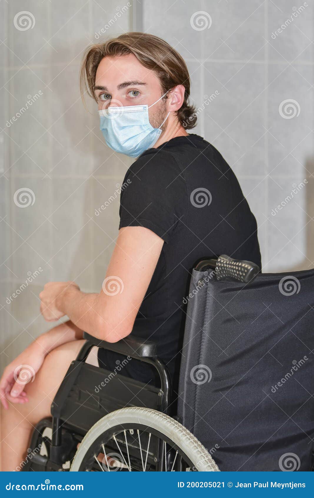 Physically Disabled Man Using a Surgical Mask Sitting on a Wheelchair ...
