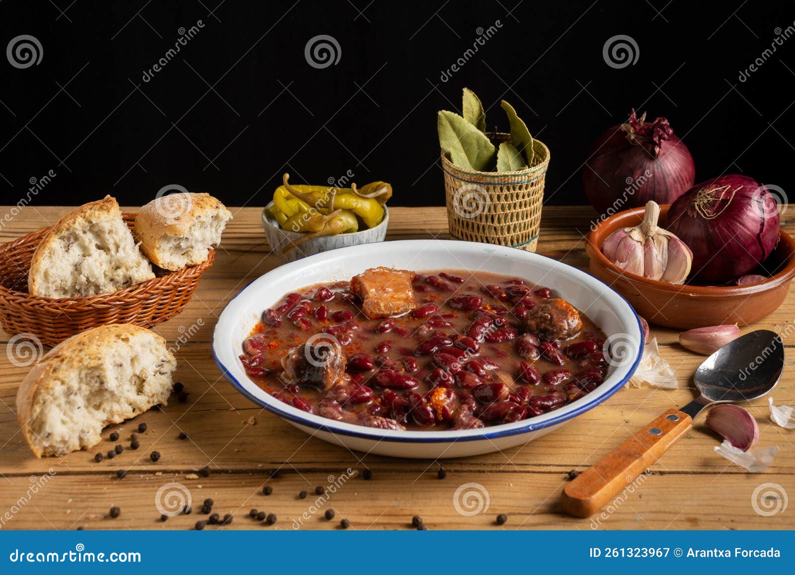 View of a Plate with Basque Bean Stew on a Rustic Table with Onions ...