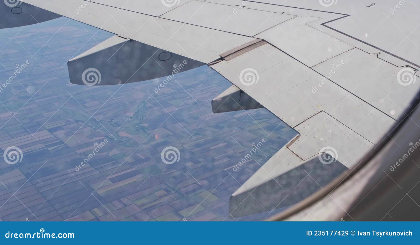 View from Porthole Window Overlooking Wing and Fuselage of the Plane ...