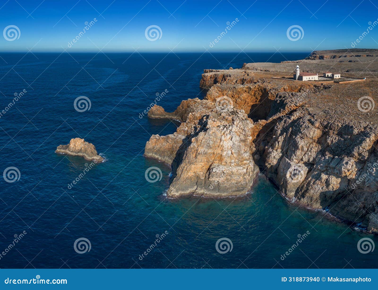 View of the Punta Nati Lighthouse and Coastal Cliffs in Northwestern ...