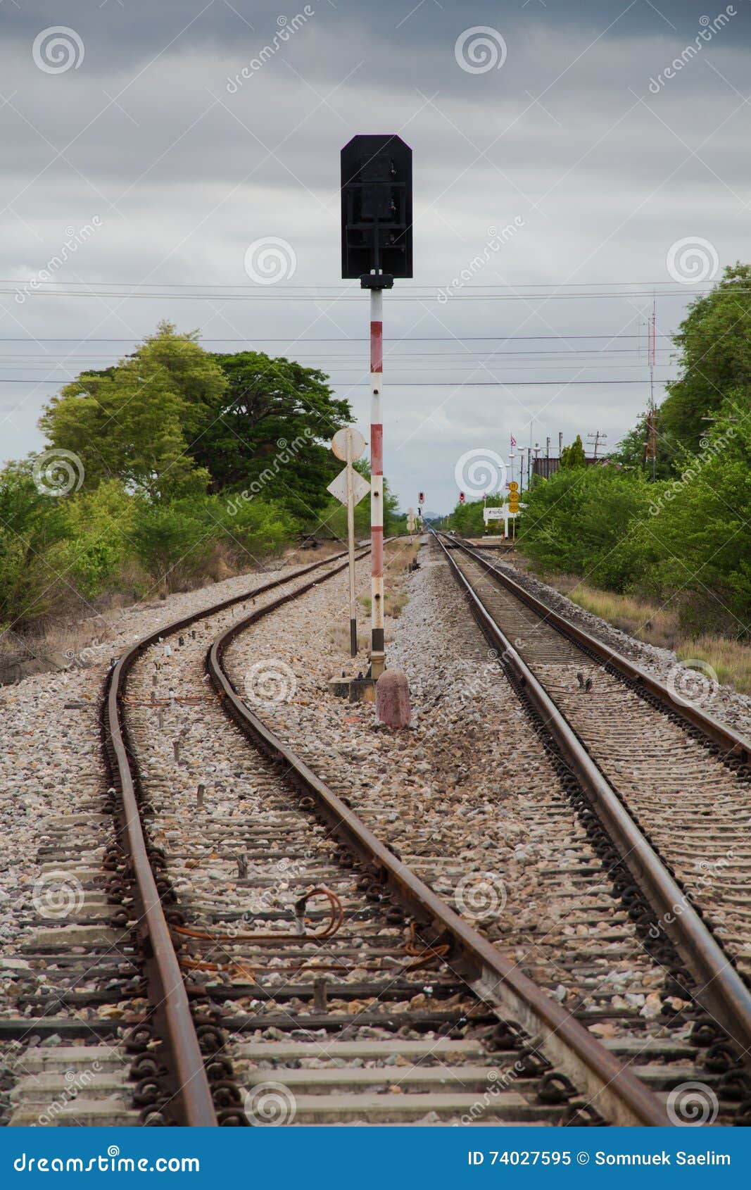 A Railroad Corssing With A Red Warning Sign And Warning Lamp And A ...