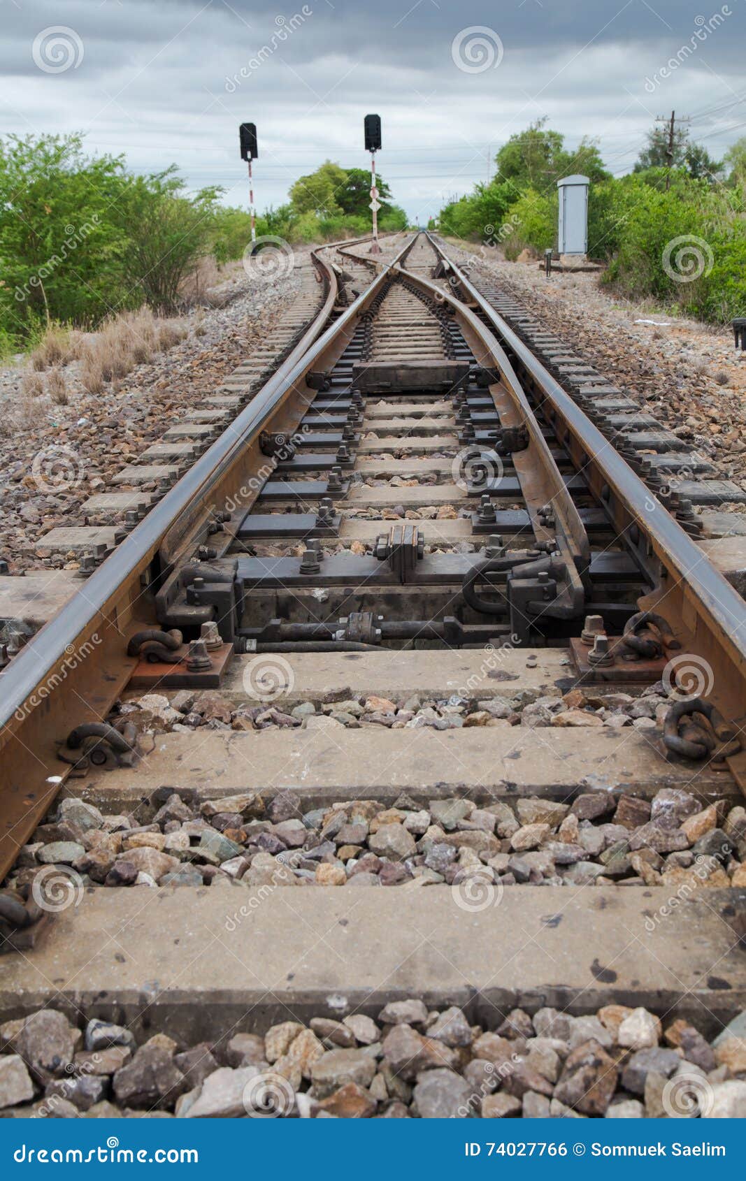 A Railroad Corssing With A Red Warning Sign And Warning Lamp And A ...