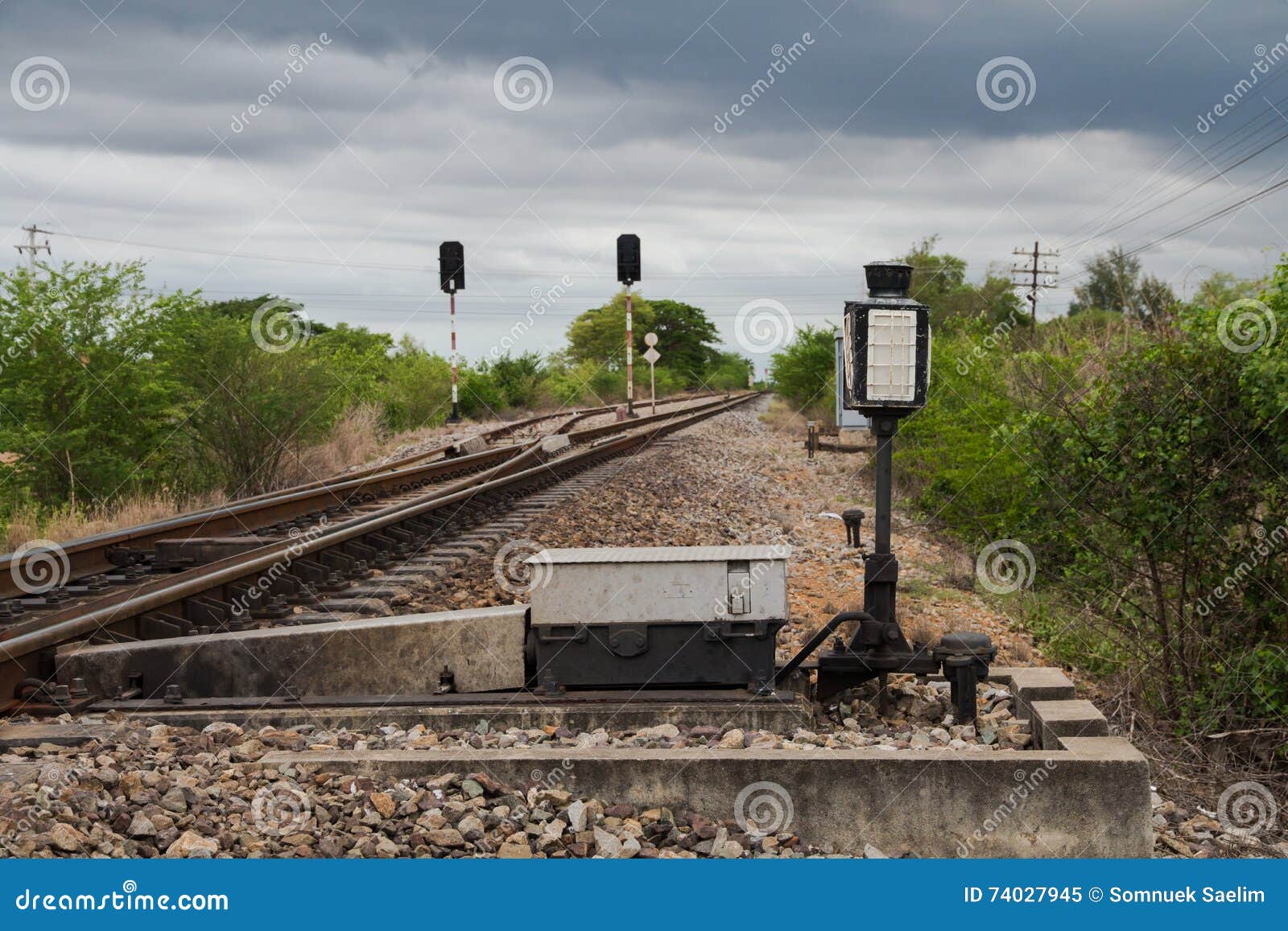 A Railroad Corssing With A Red Warning Sign And Warning Lamp And A ...