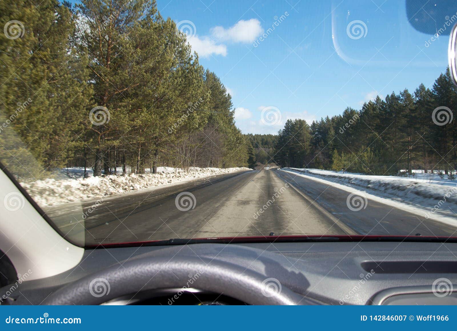 View of the Road through the Windshield. Snow on the Sidelines. Wet ...
