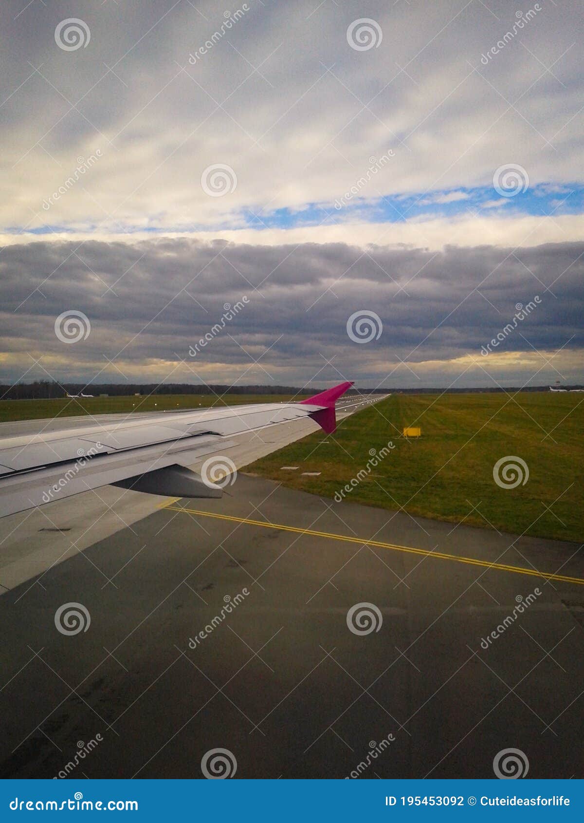 View of the Runway and the Wing of the Plane through the Porthole Stock ...