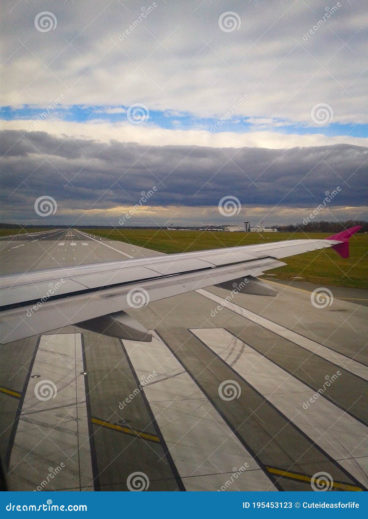 View of the Runway and the Wing of the Plane through the Porthole Stock ...
