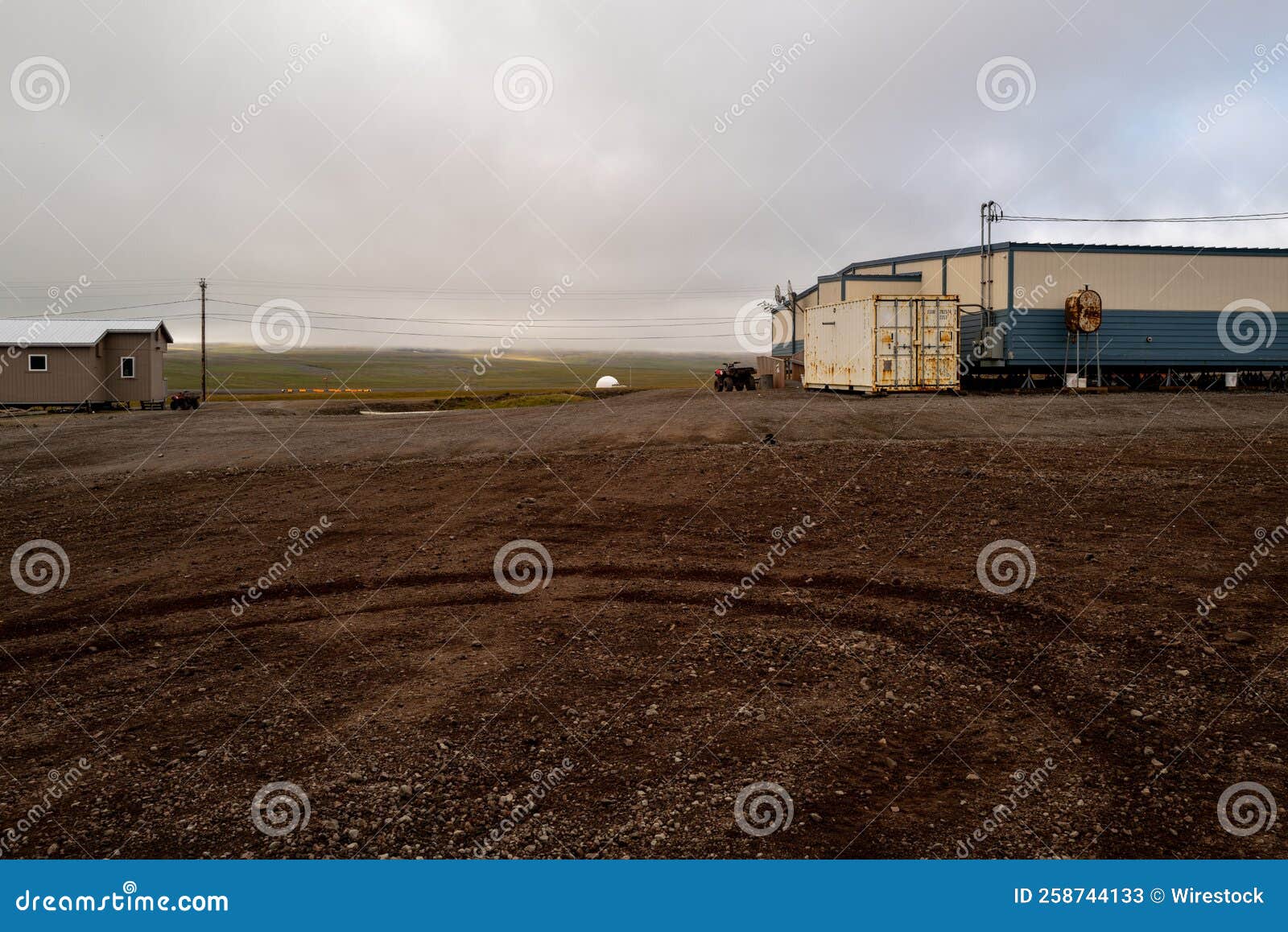 View of a Rusty Container and Quad Bike in a Field Under the Cloudy Sky ...