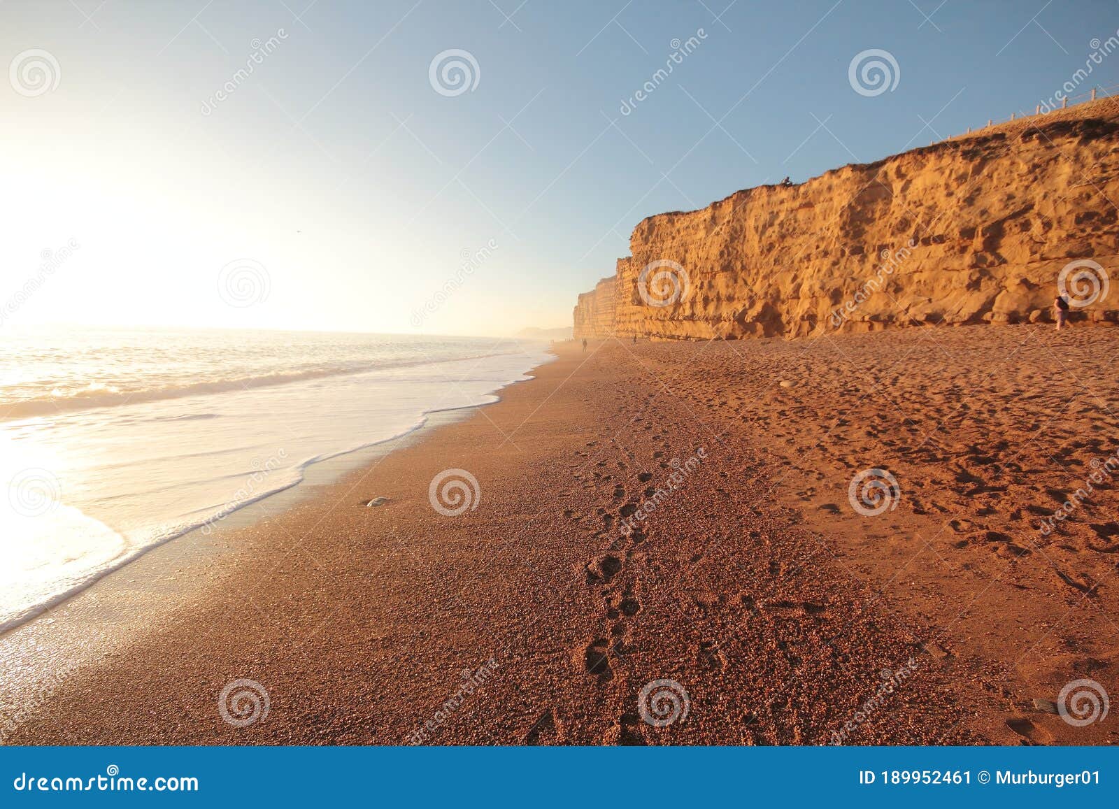 A View of a Sandy Beach with the Tide Retreating and Sandy Cliffs Stock ...