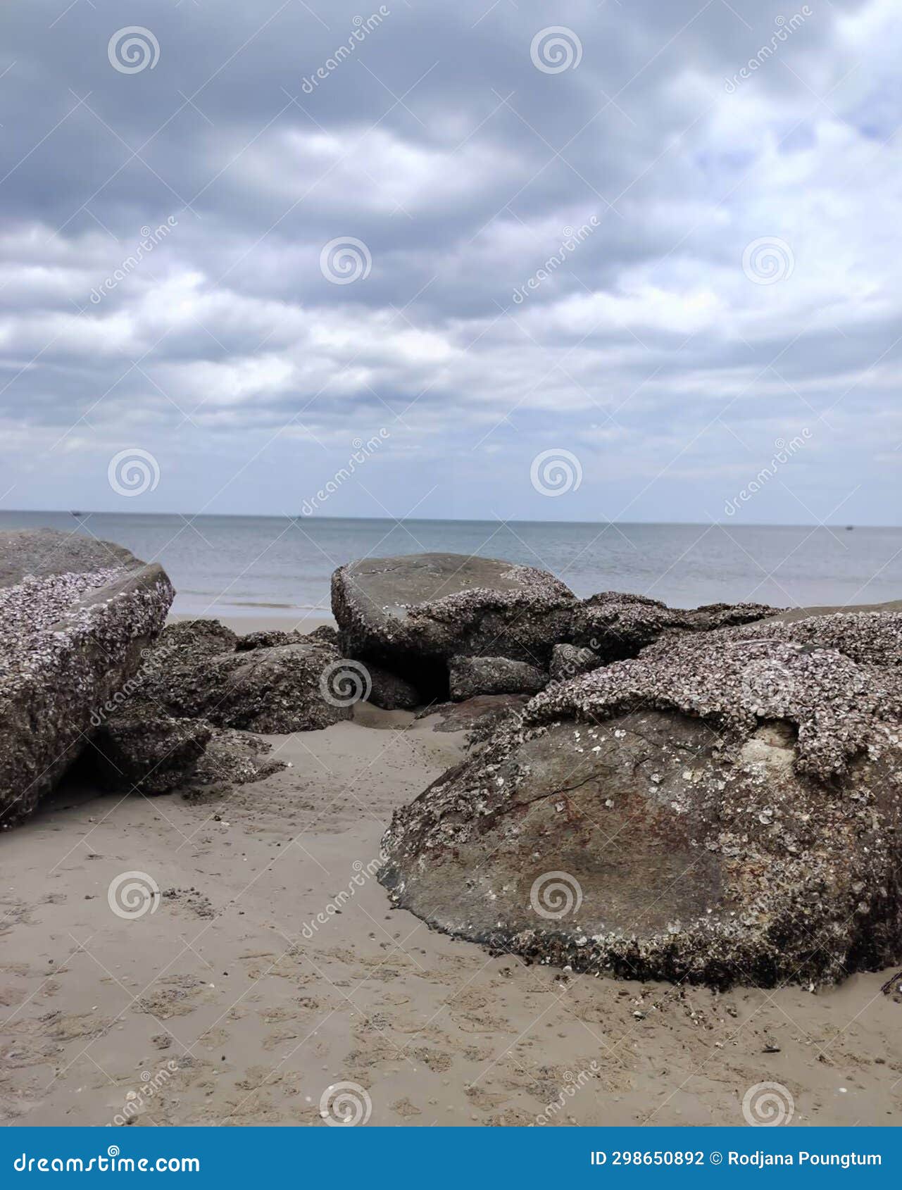 A View of the Sea with Large Rocks Lining the Beach Stock Photo - Image ...