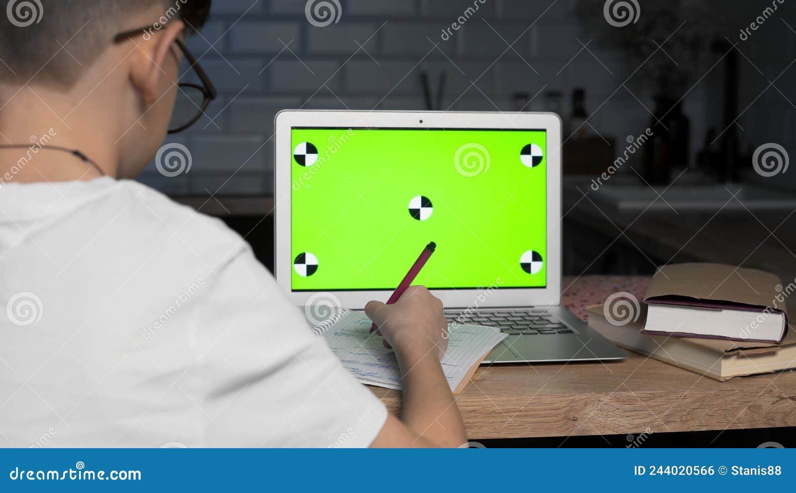 A View from the Shoulder of a Boy Doing Homework. the Green Screen on ...