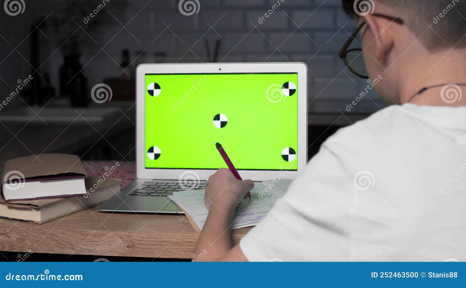 A View from the Shoulder of a Boy Doing Homework. the Green Screen on ...