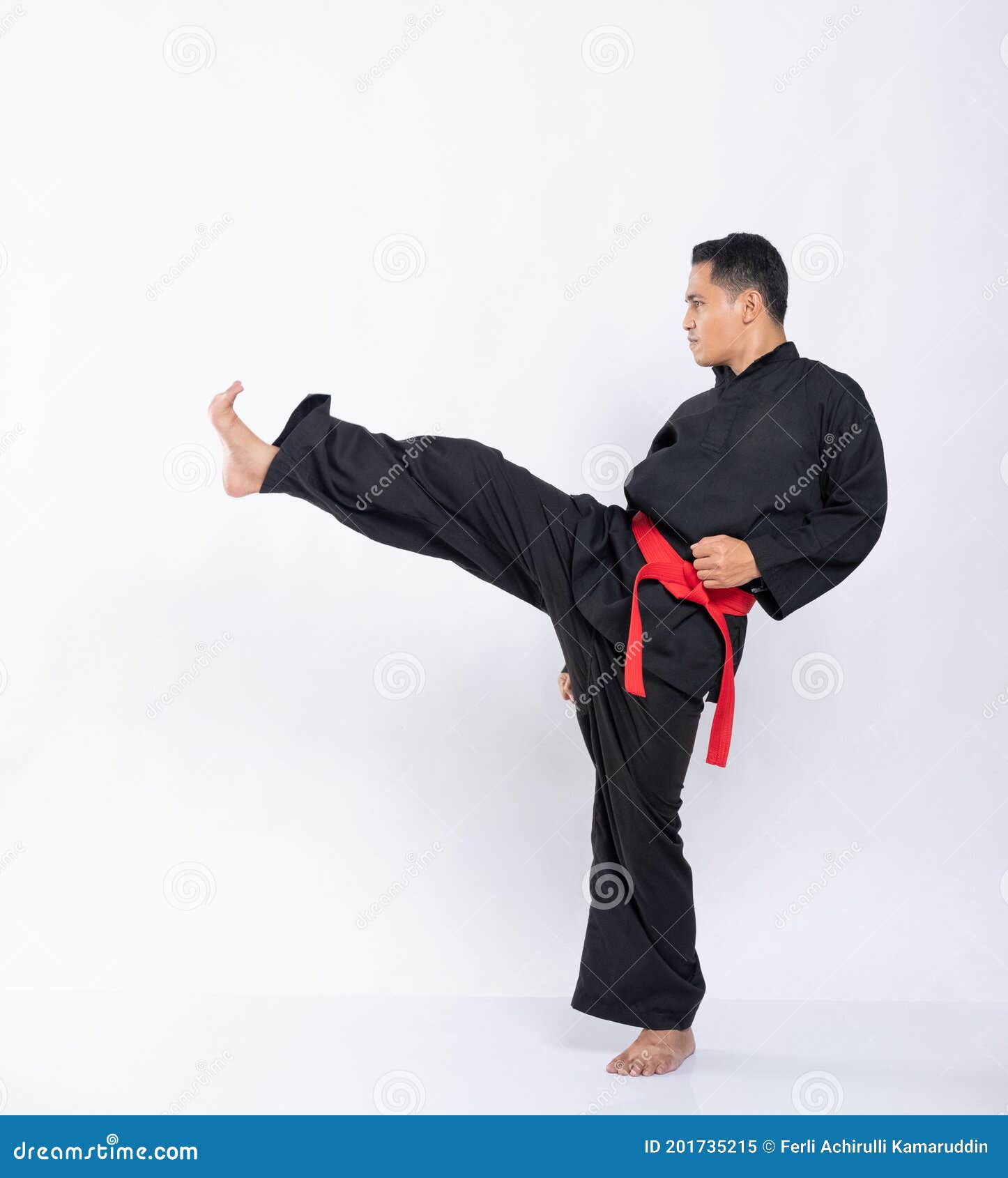 View Side of an Asian Man with an Attacking Pose Kicking Forward while ...
