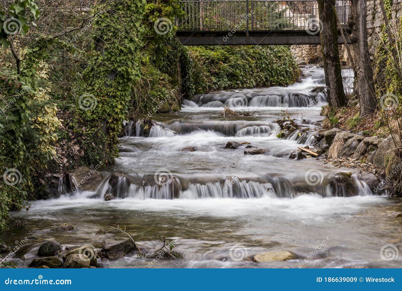 View of Small Cascading Waterfalls Under a Bridge Stock Image - Image ...