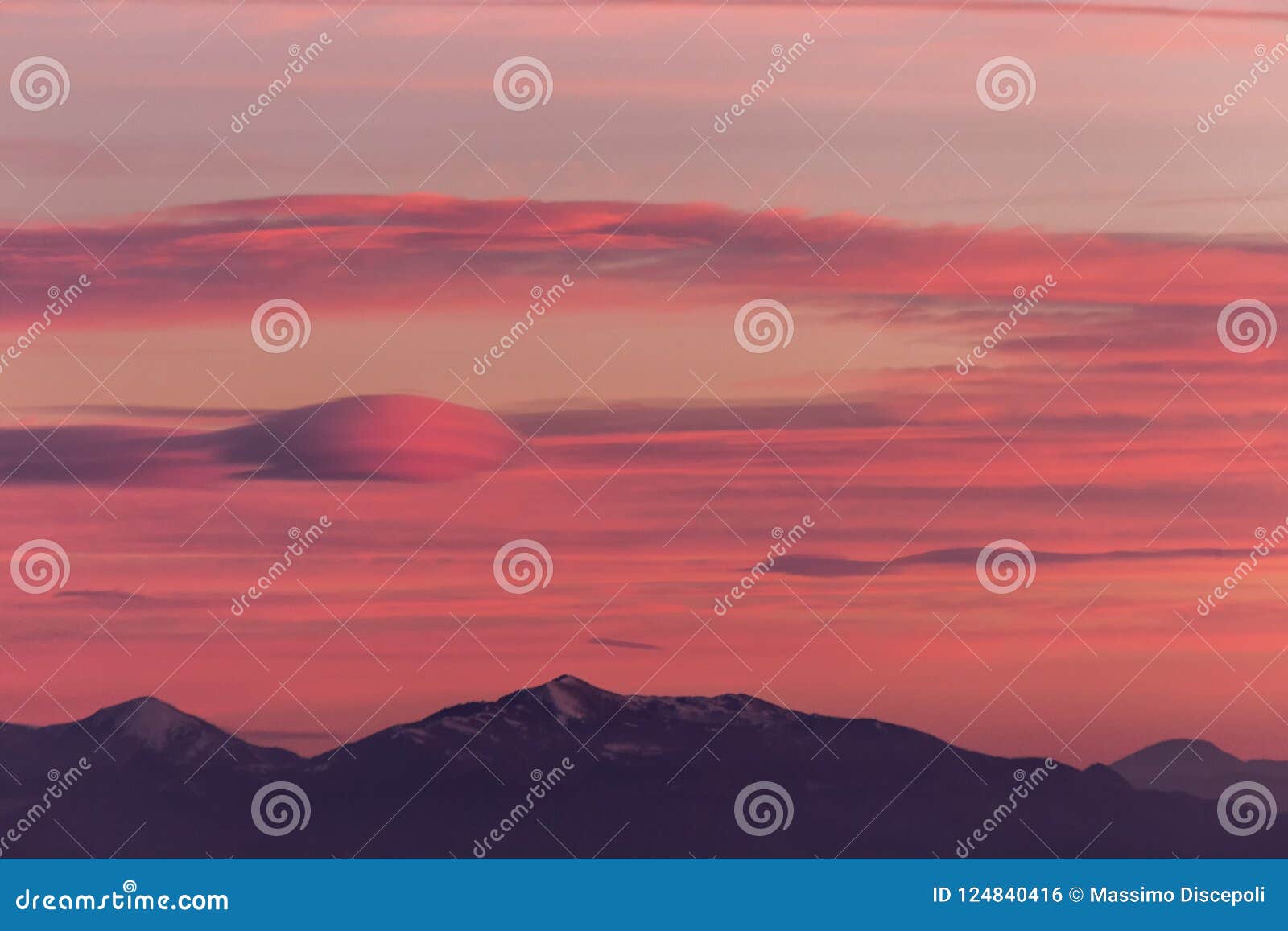 A View of Some Mountains Top, Beneath a Beautiful, Warm Colored Sky at ...