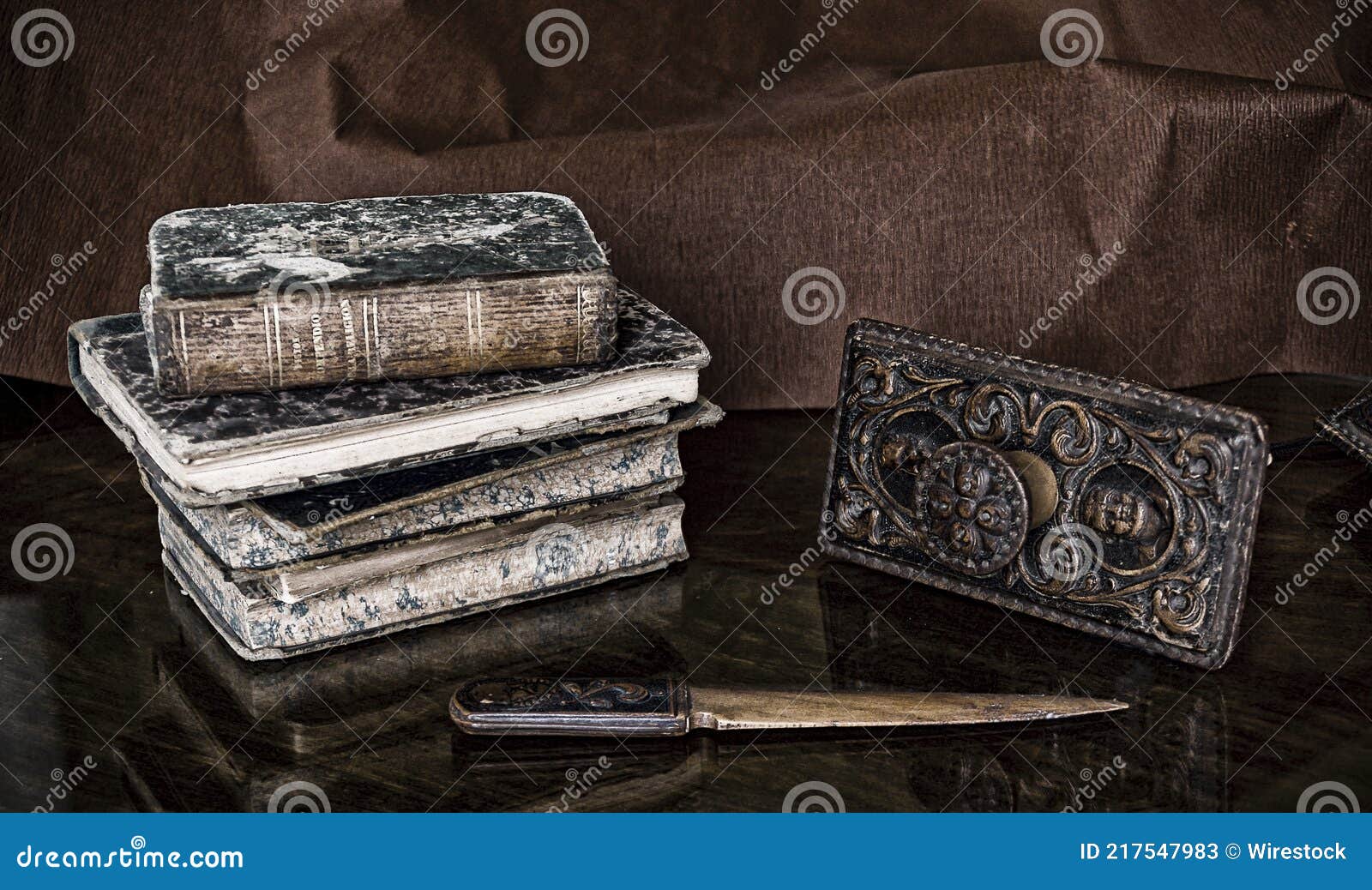 View at a Stack of Ancient Stained Books by a Metallic Artifact and an ...