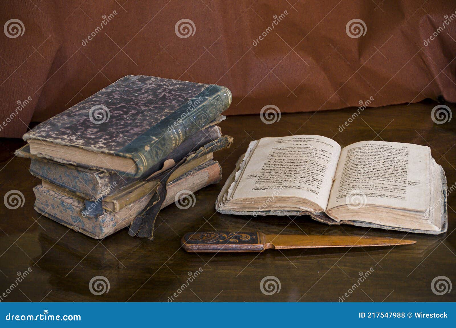 View at a Stack of Ancient Stained Books by an Opened Book and an Old ...