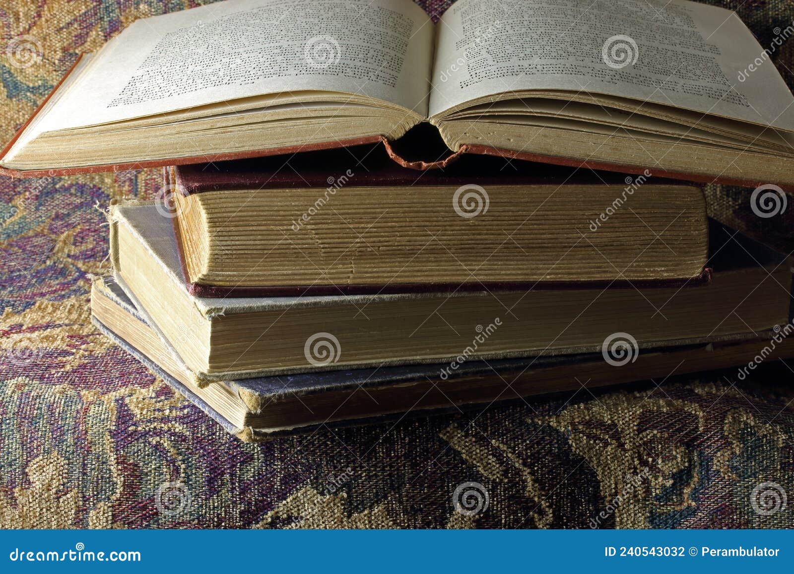 An OPEN BOOK on a STACK of BOOKS Editorial Photography - Image of cloth ...