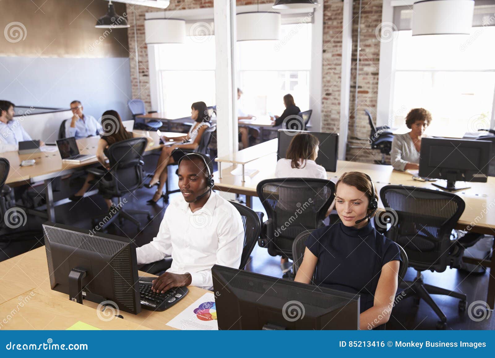 View of Staff in Busy Customer Service Department Stock Photo - Image ...