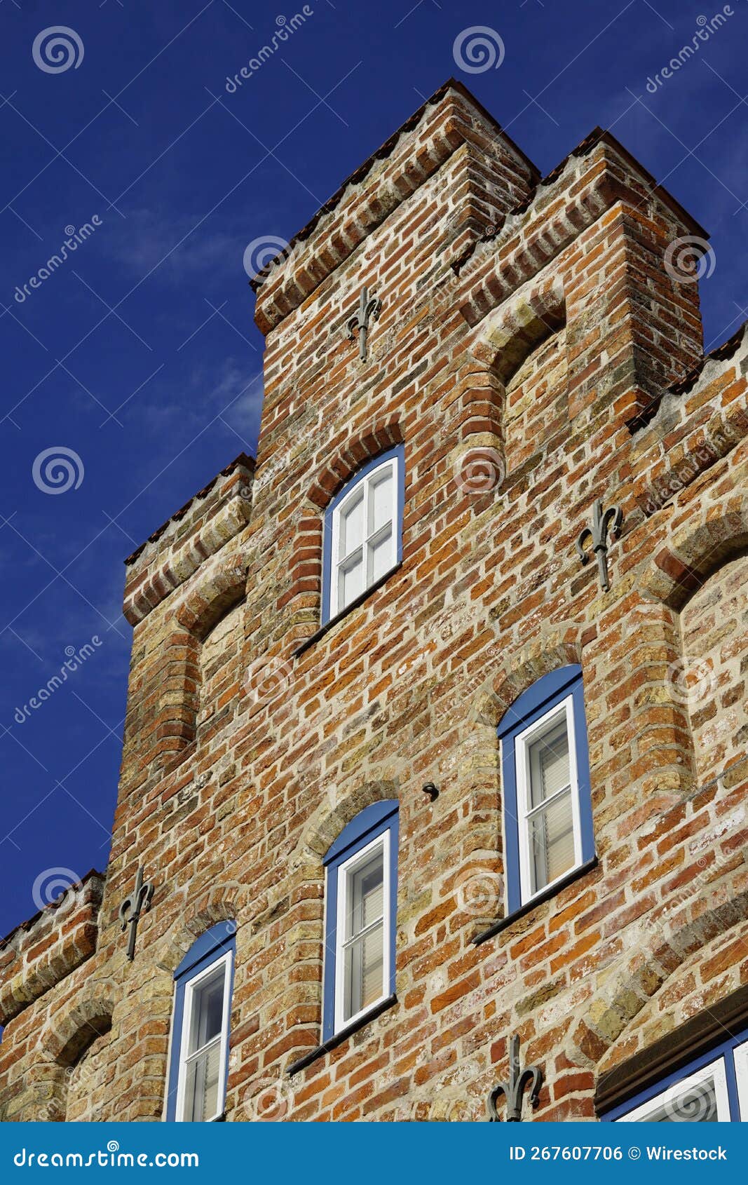 View of a Stepped Roof Building with a Brick Wall and Small Windows ...