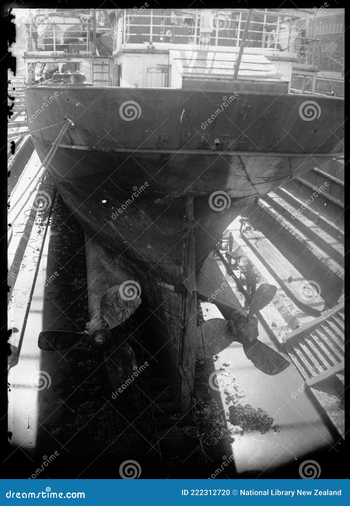 View Of The Stern Of A Ship Showing The Propellers With Men Working At ...