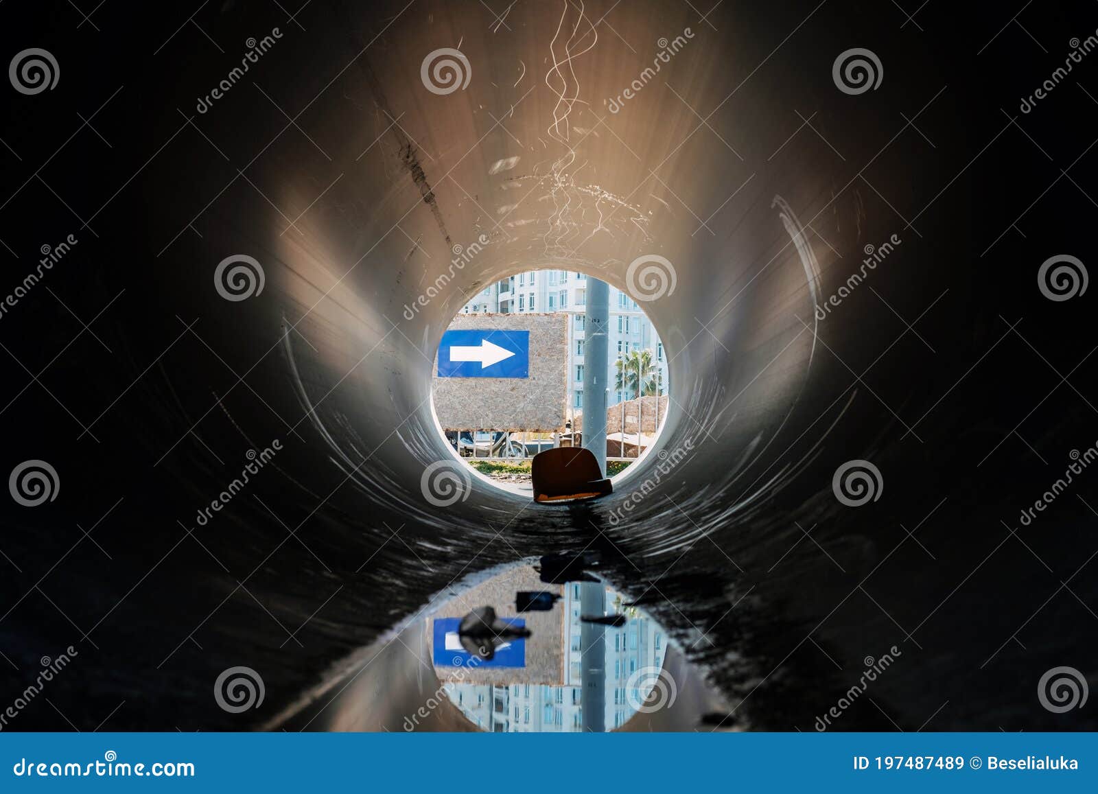 A View of a Street Reflecting on the Puddle Inside of a Scratched Tube ...