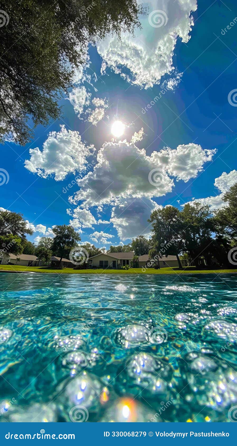 A View of the Sun Shining through the Clouds Over a Swimming Pool Stock ...