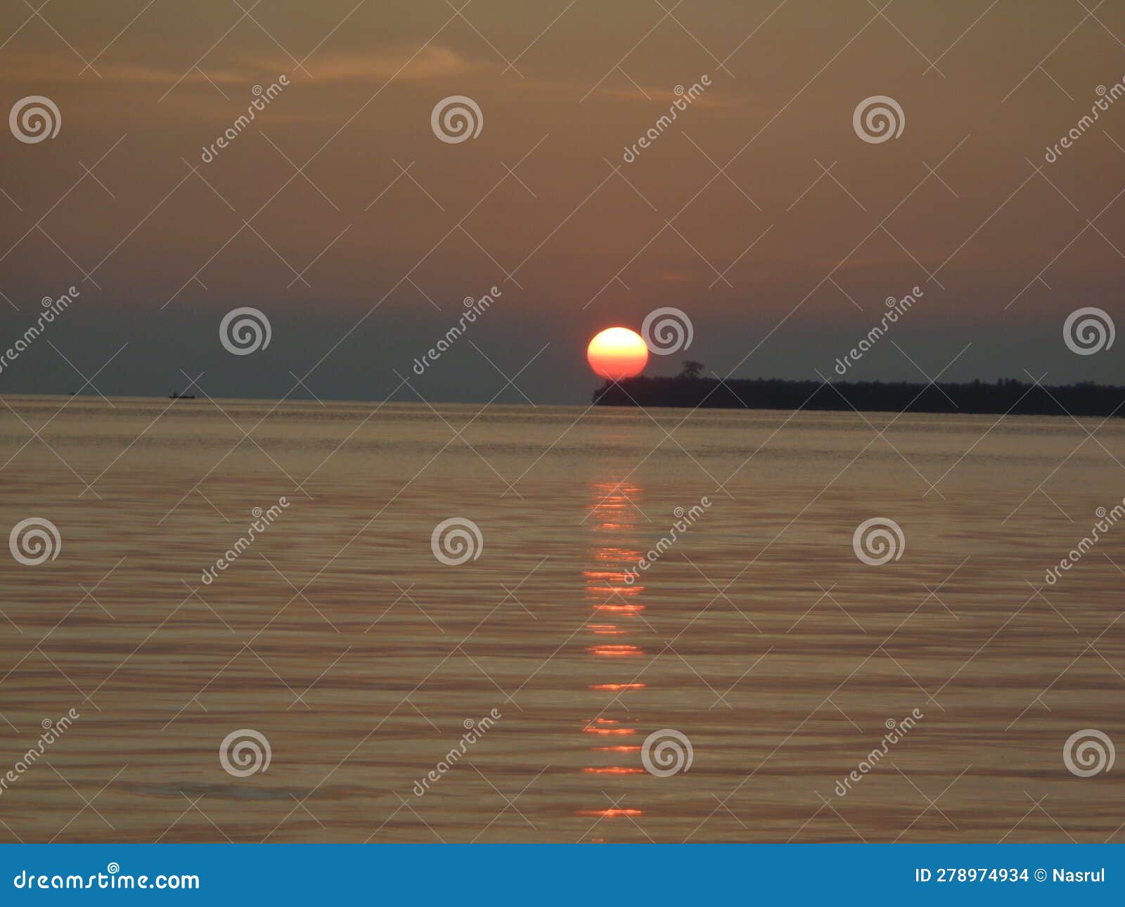 A View of a Sunset almost Drowning in the Sea Stock Photo - Image of ...