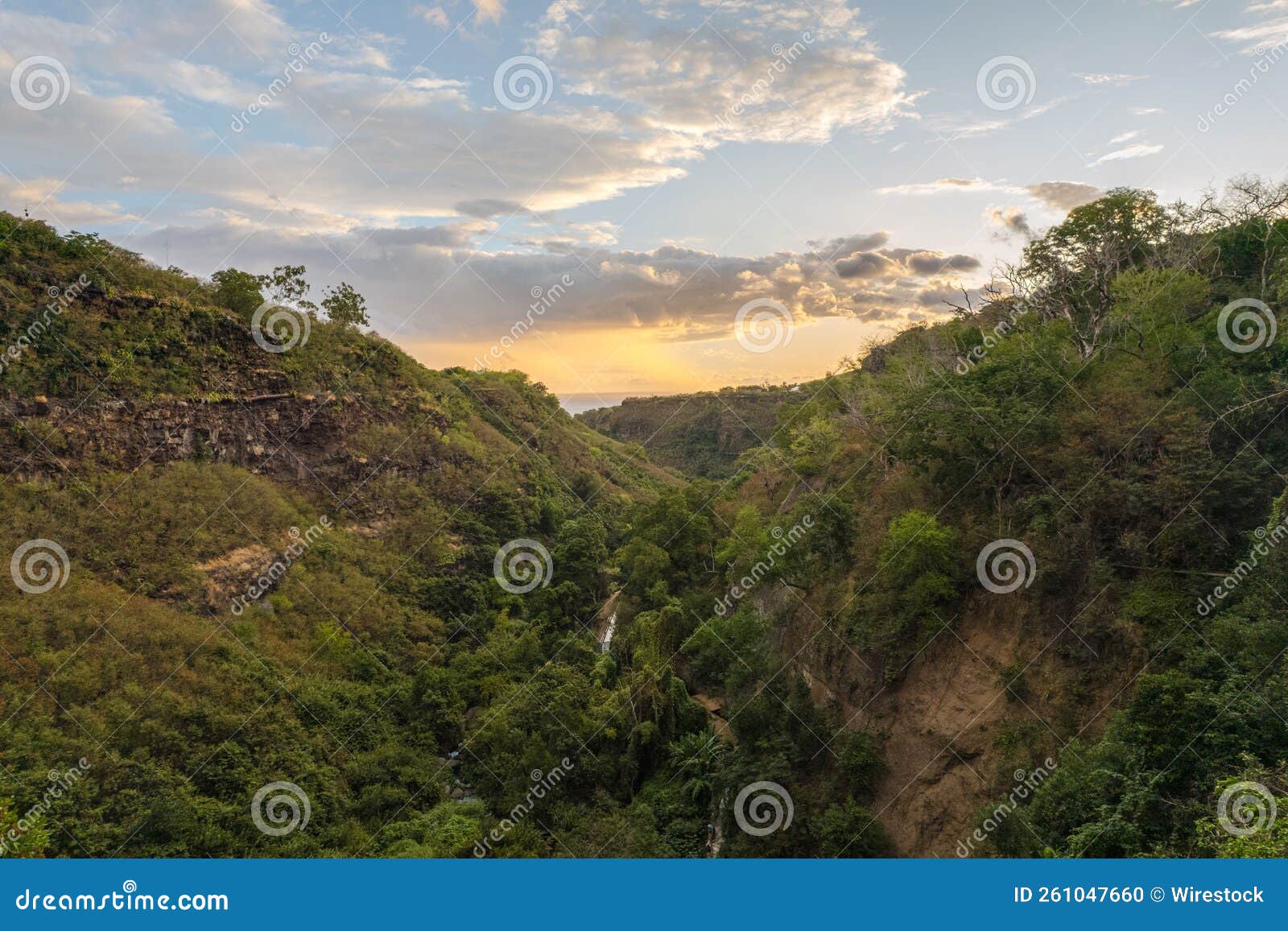 View of the Sunset from the Gorge of Mountains Covered with Green Grass ...