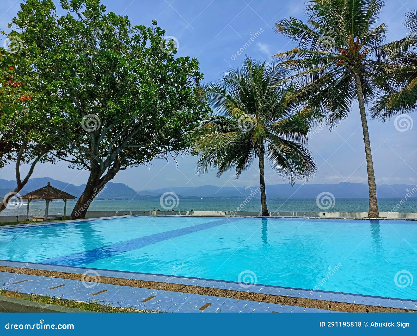 View of the Swimming Pool with a Beach and Clear Sky in the Background ...