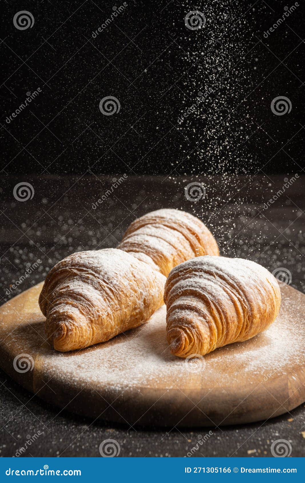 View of Three Croissants on Table with Sugar Falling, Wooden Table ...
