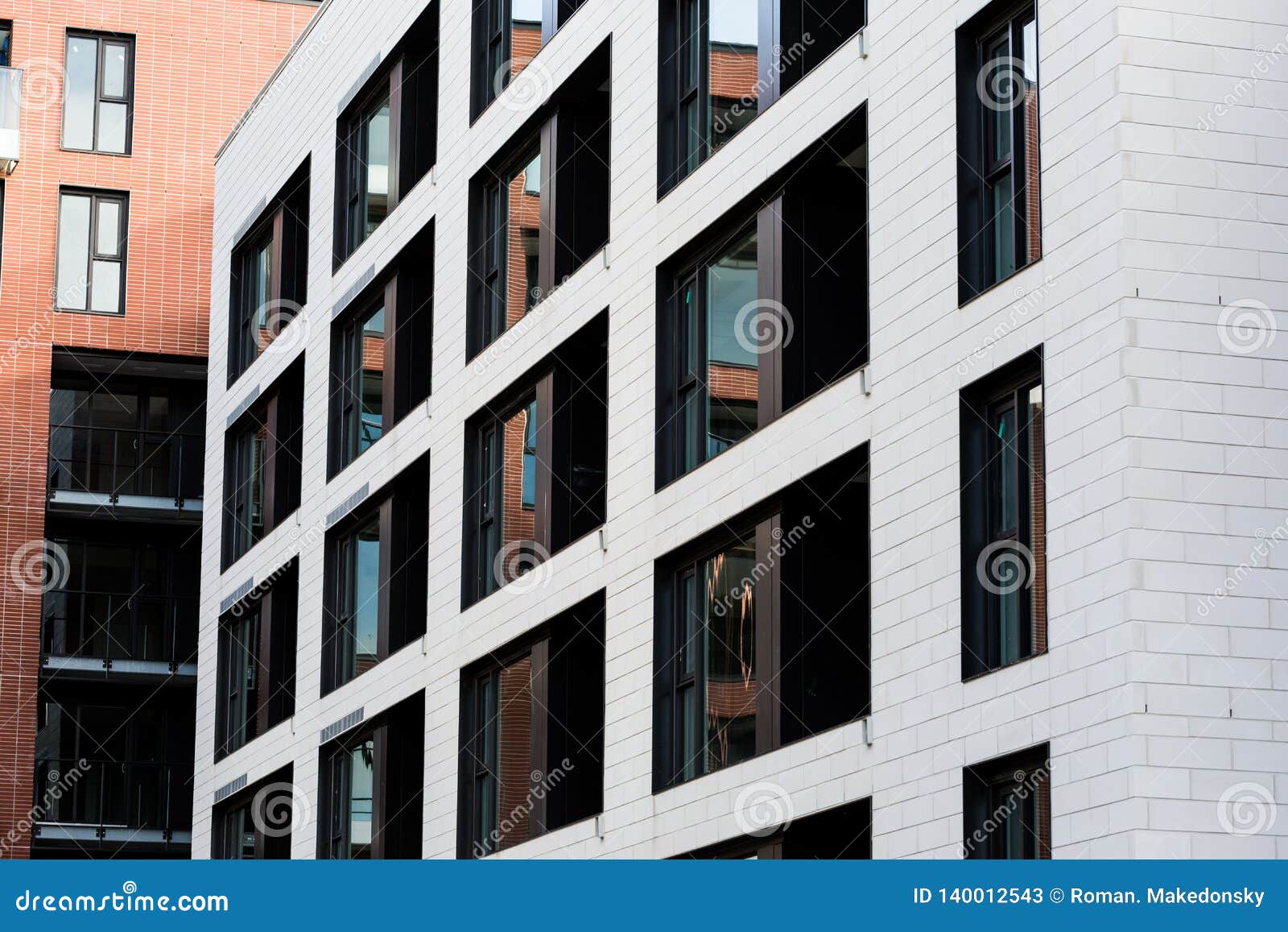 View on New Construction Brick Apartment Complex Square Windows. Modern ...