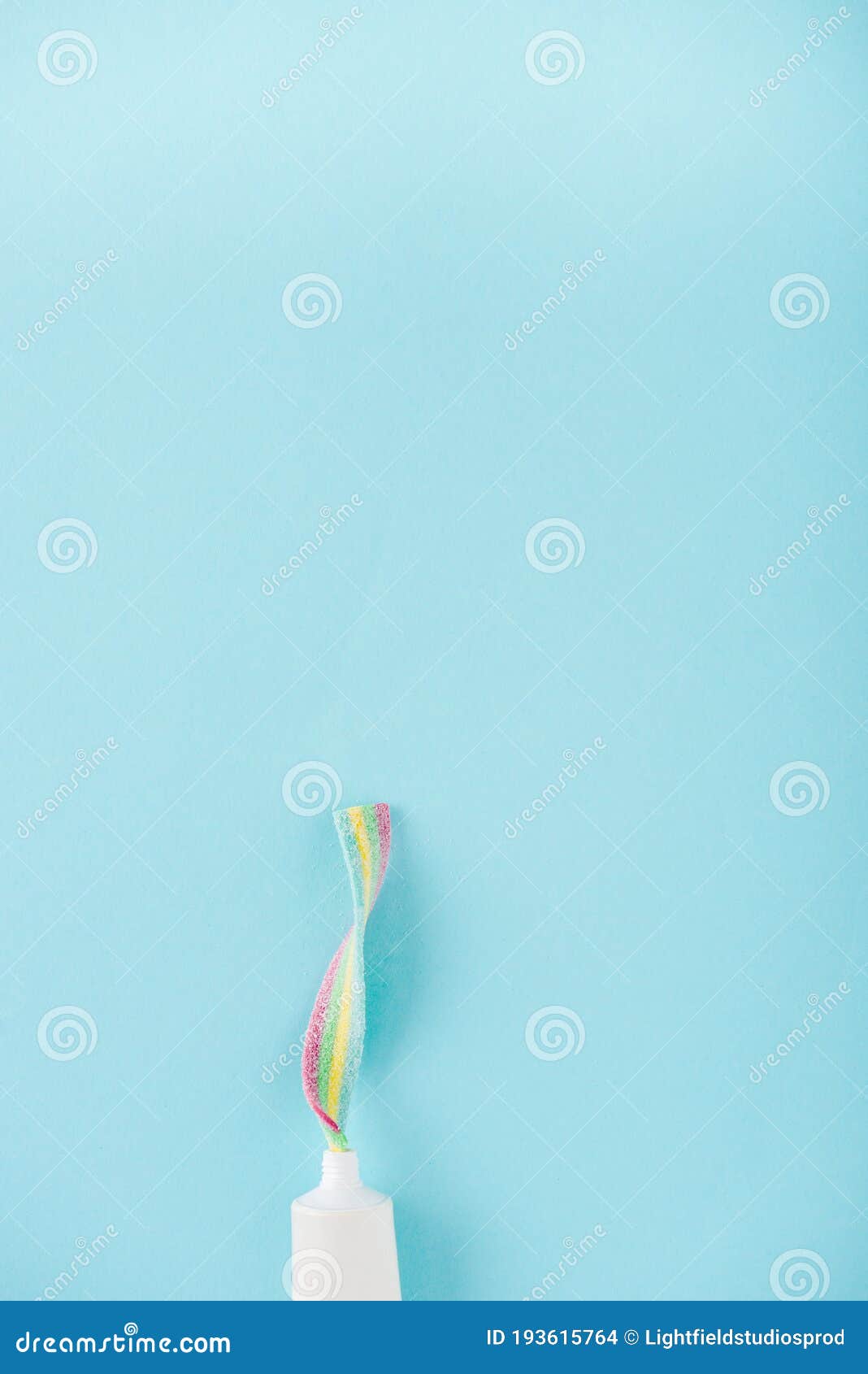 View of Toothpaste Tube with Chewing Candy Isolated on Blue with Copy ...