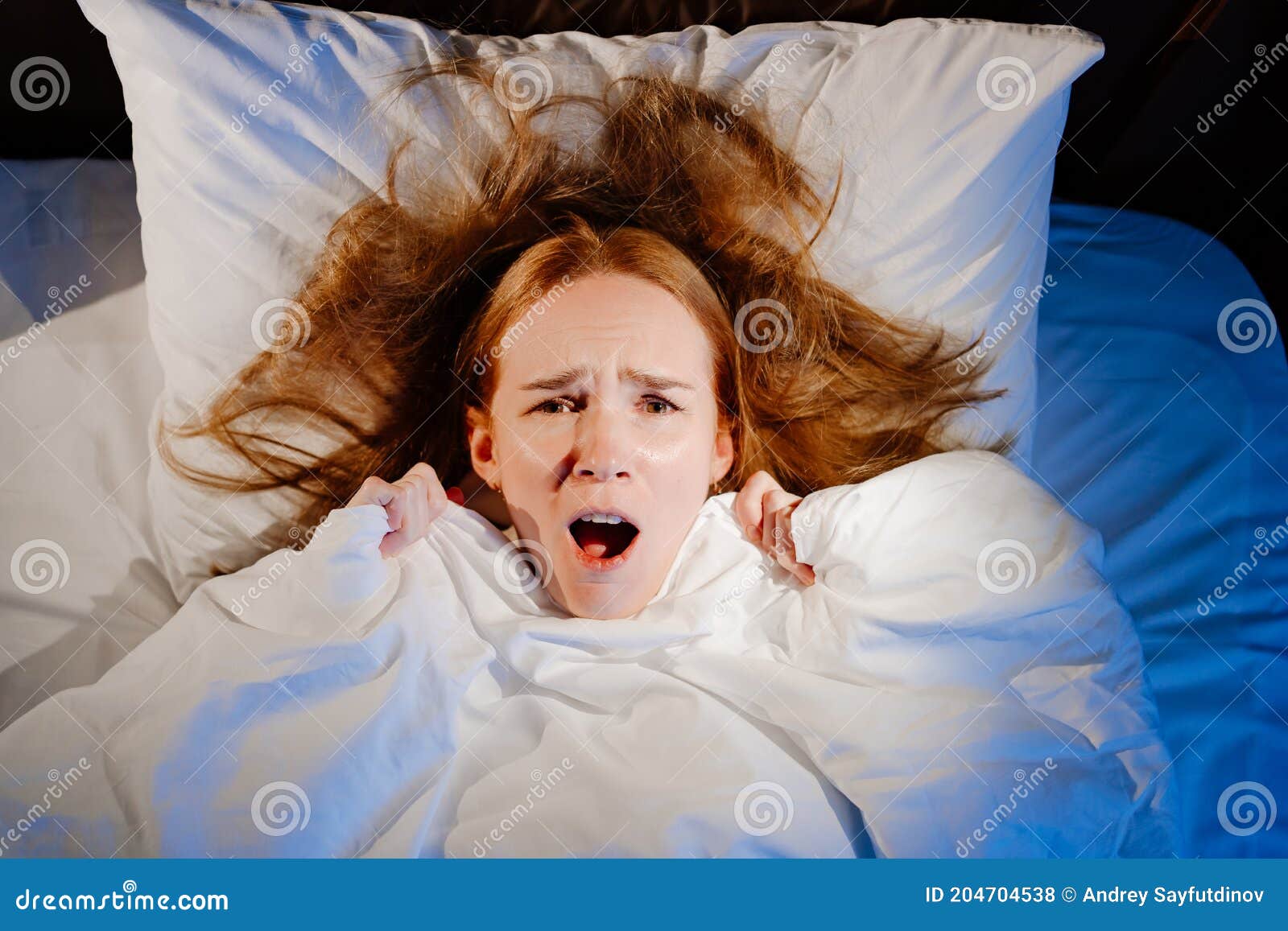 View Top A Woman Lies In Bed Under A White Blanket And Afraid