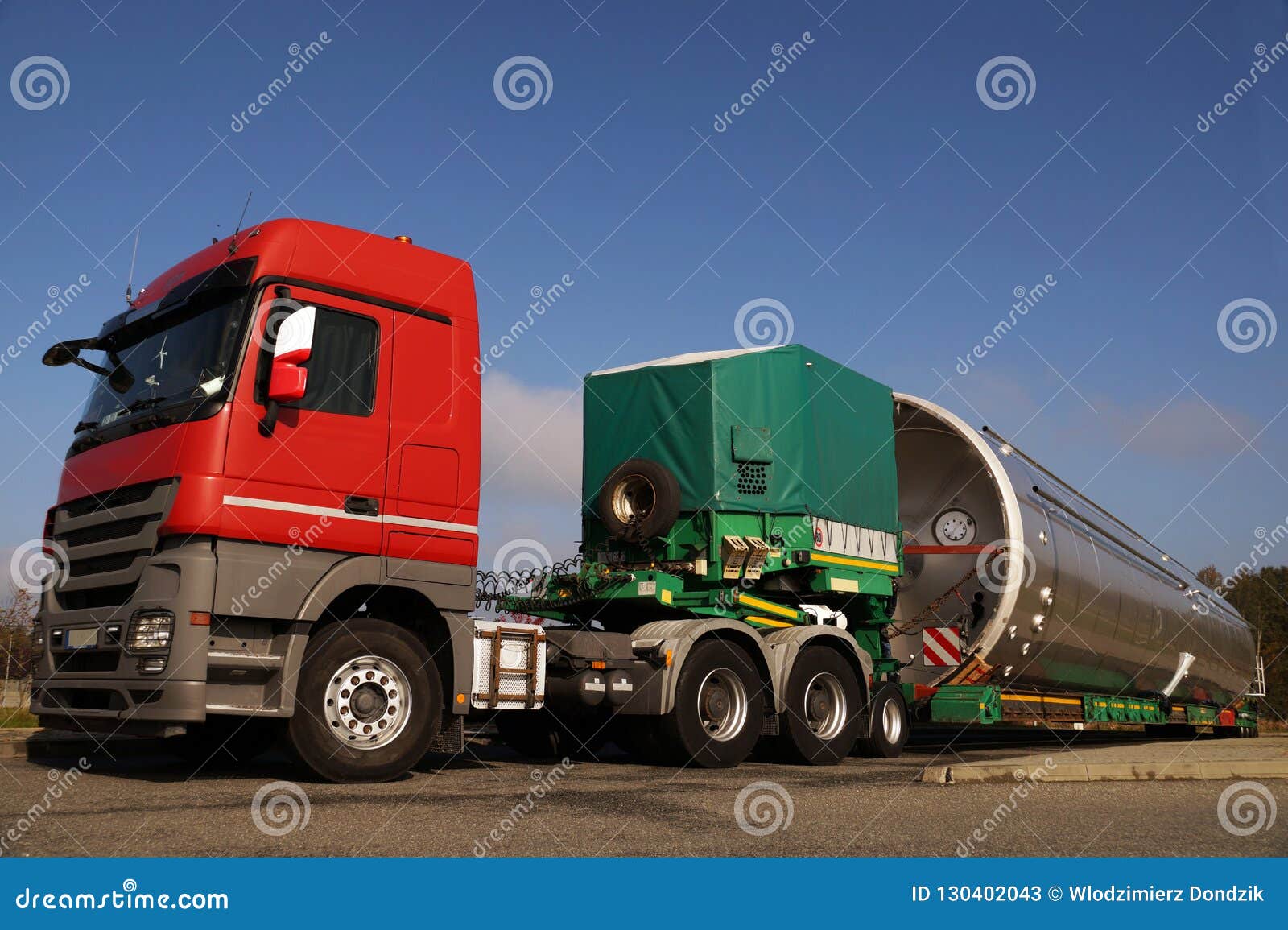 A View of a Truck, a Low-loader Semi-trailer and an Oversized Ca ...