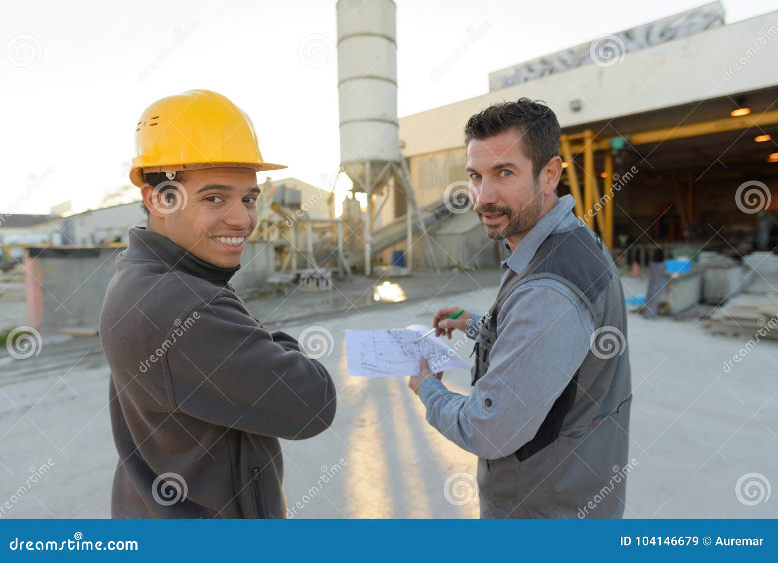 View Two Workers Working Outside on Construction Site Stock Image ...