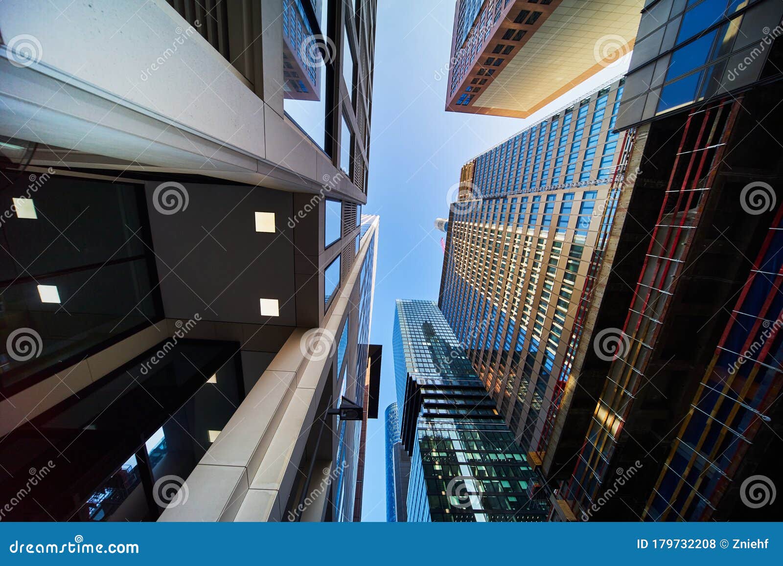 Vertical Upwards View Of A Modem Office Building With A Blue Cloudy Sky ...